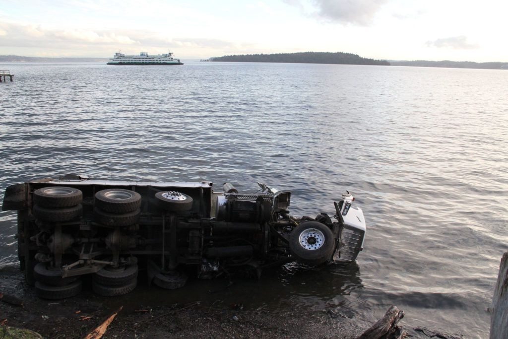 Truck driver misses curve, flips truck onto South Beach | Bainbridge ...
